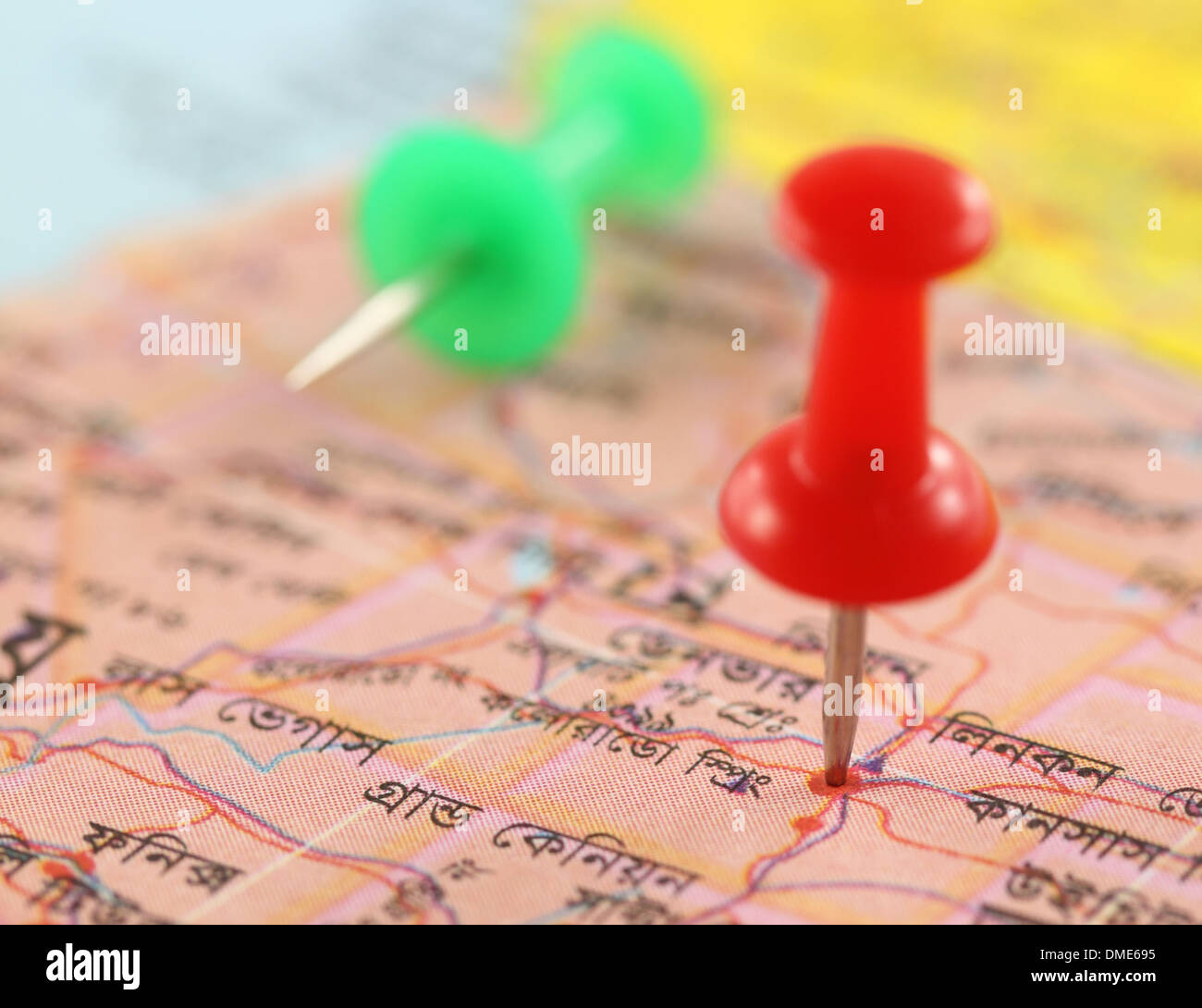 Pushpin pointing place on a paper map Stock Photo - Alamy
