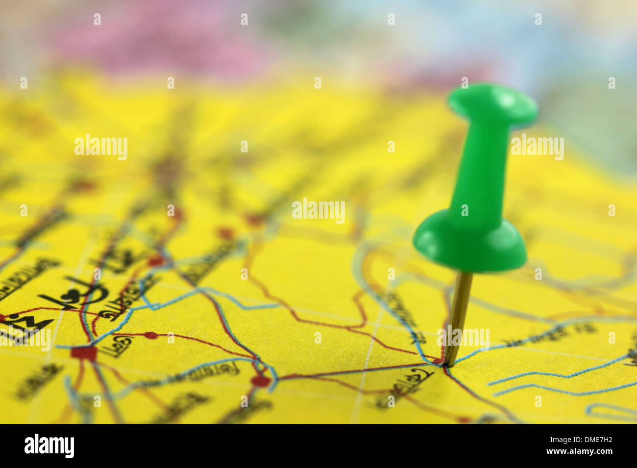 Pushpin pointing place on a paper map Stock Photo - Alamy