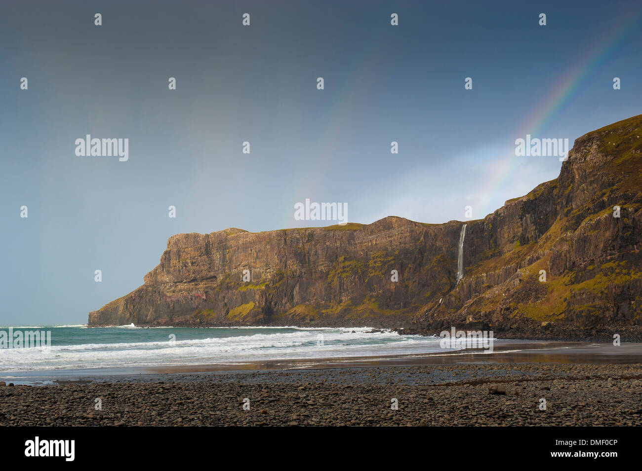 A rainbow appearing over the waterfall on Talisker Bay, Syke on a ...