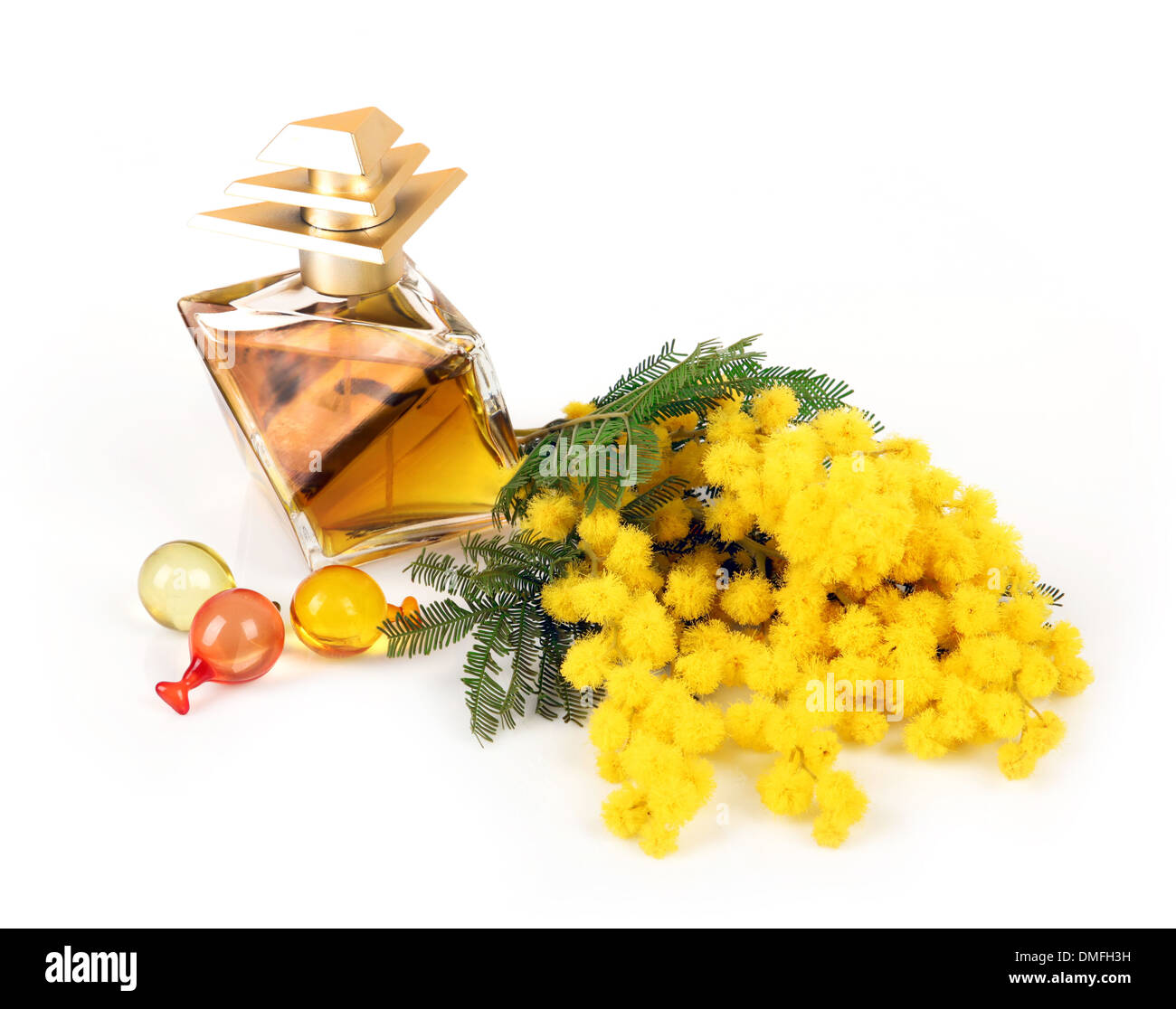 Perfume of mimosa flowers on white background Stock Photo - Alamy