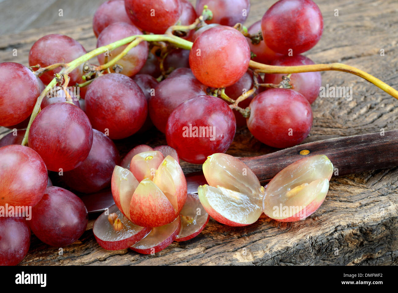 rose wine and grapes on old wooden table Stock Photo - Alamy