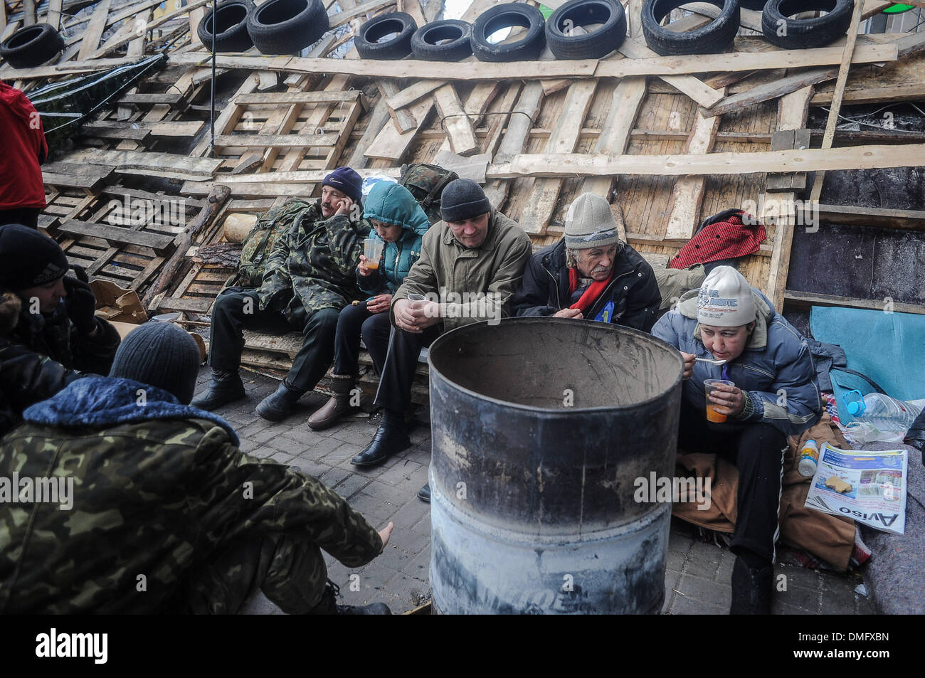 Kiev, Ukraine. 13th Dec, 2013. Protesters warm themselves near a fire ...