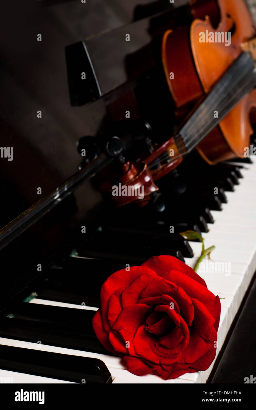 Violin and piano closeup with red rose for concert advertisement with ...