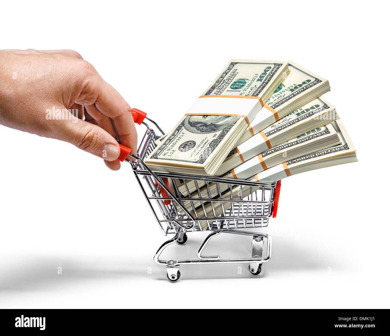 Hand pushing shopping cart full of stacks of dollar bills Stock Photo ...