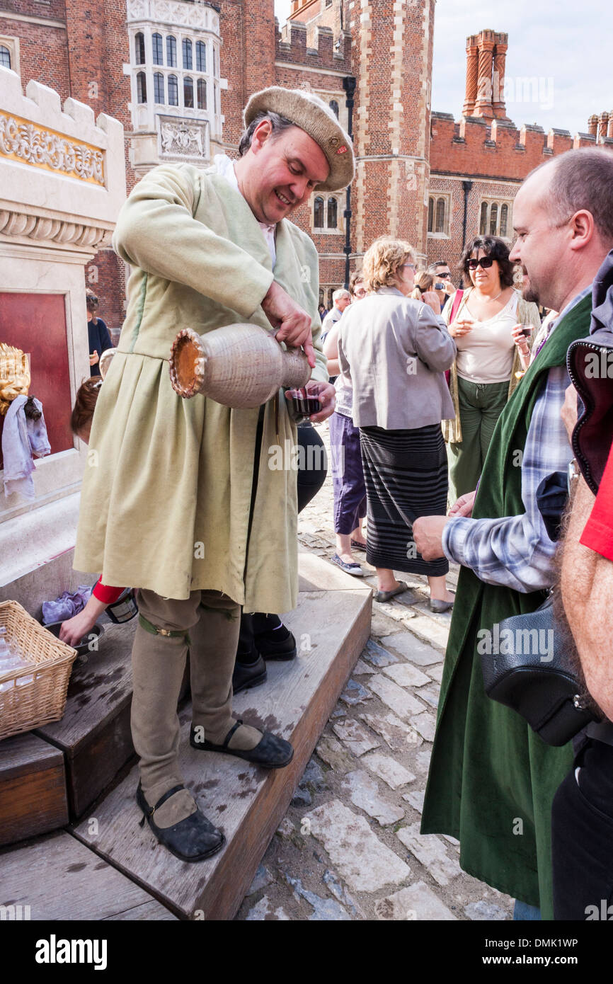 Actor in period costume serves glasses of wine at the Henry VIII wine ...
