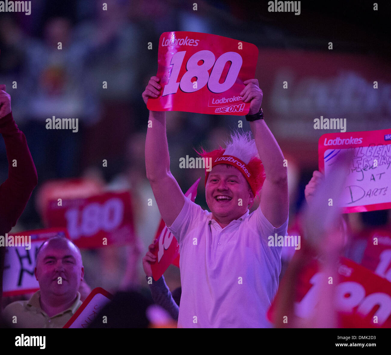 London, UK. 13th Dec, 2013. A darts fan celebrates a 180 score during ...