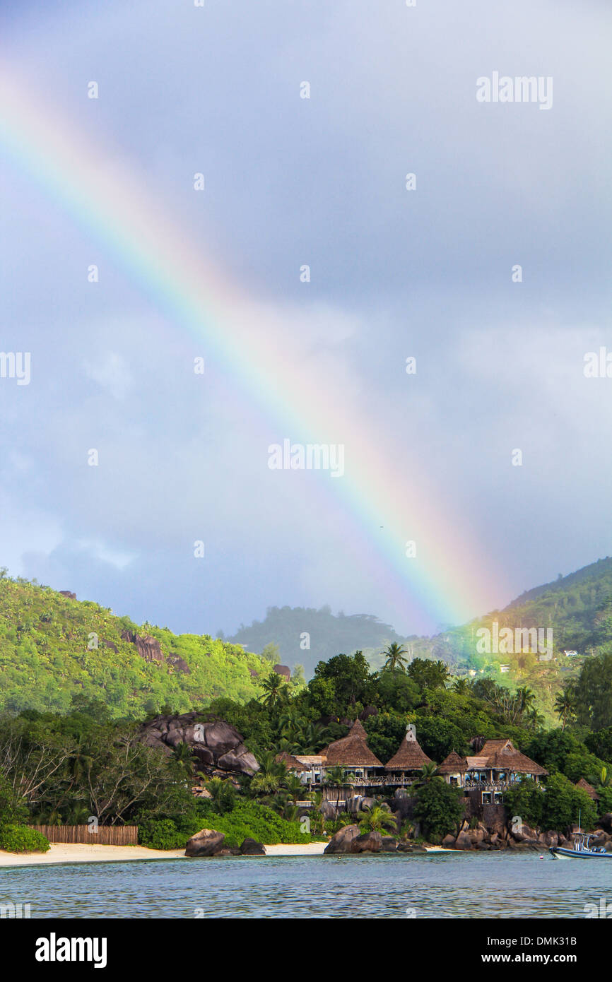 Rainbow over tropical island and luxurious hotel Stock Photo - Alamy