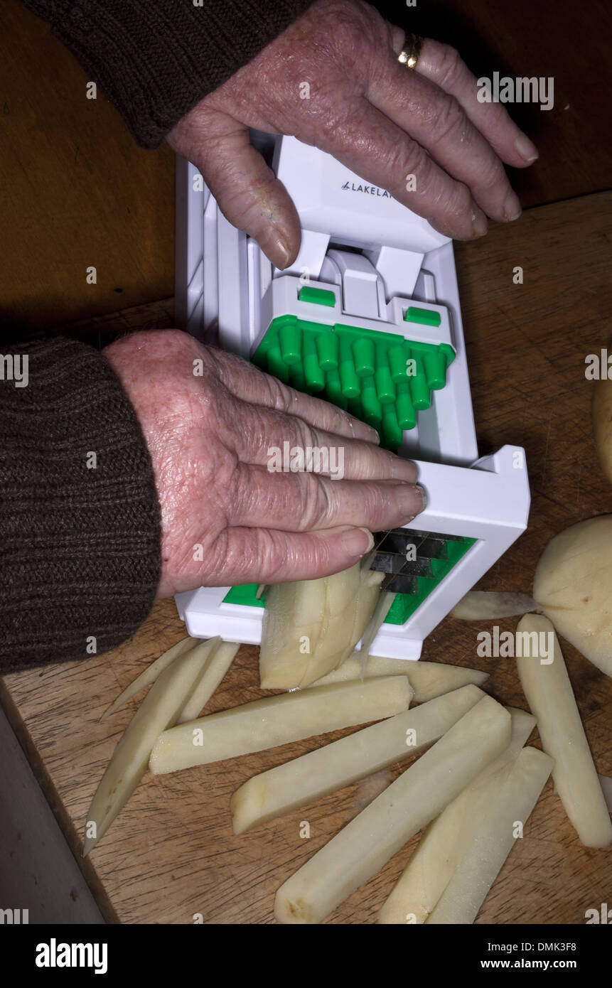 Senior cutting chips with a chip cutter Stock Photo - Alamy