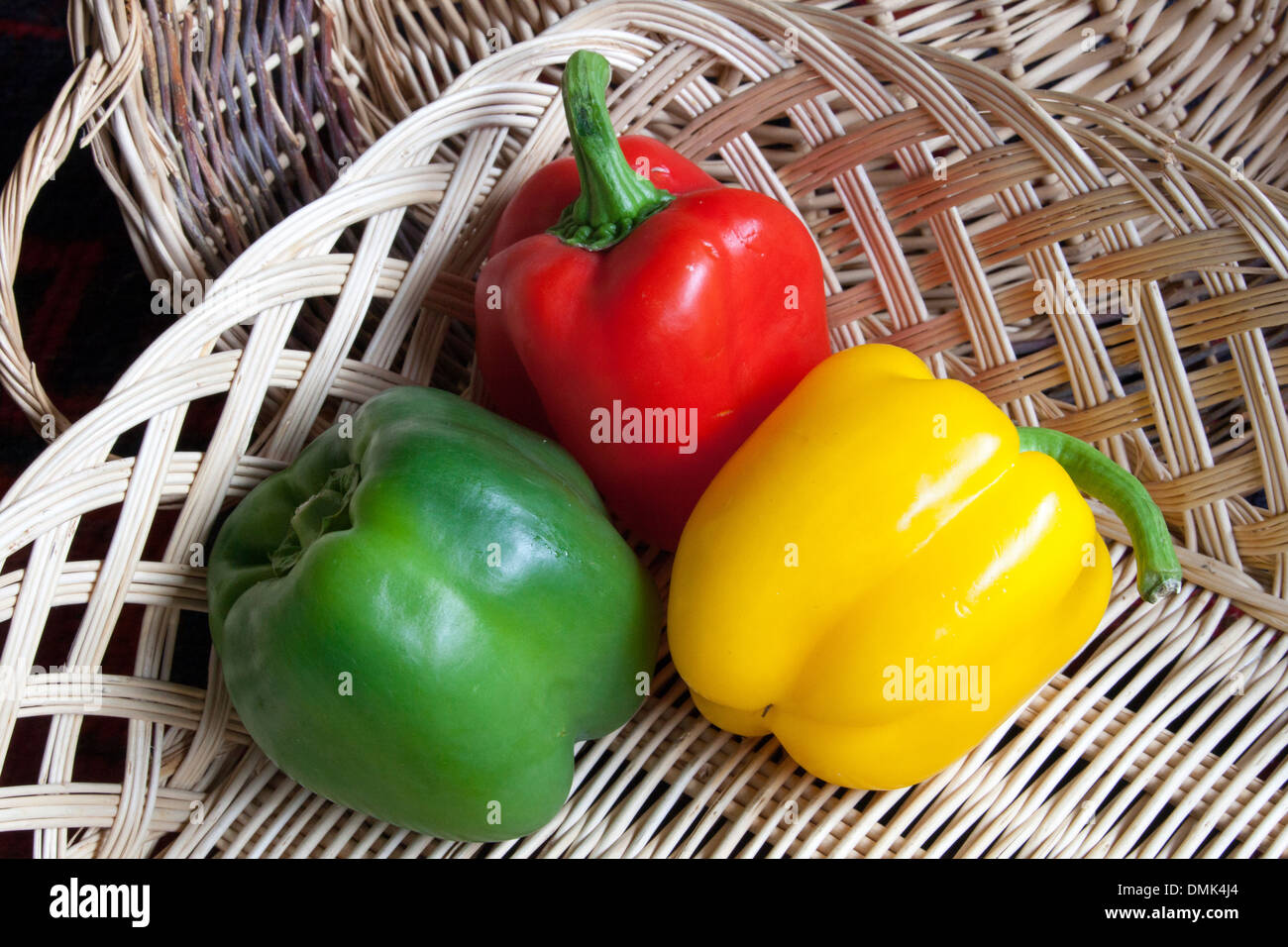 3 peppers in a wicker basket Stock Photo - Alamy