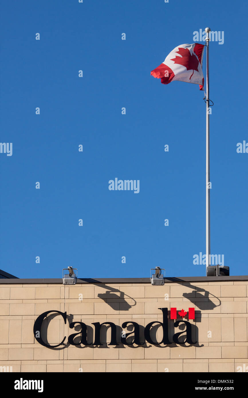CANADIAN FLAG AND OFFICIAL LOGO OF CANADA ON THE FACADE OF A CANADIAN ...