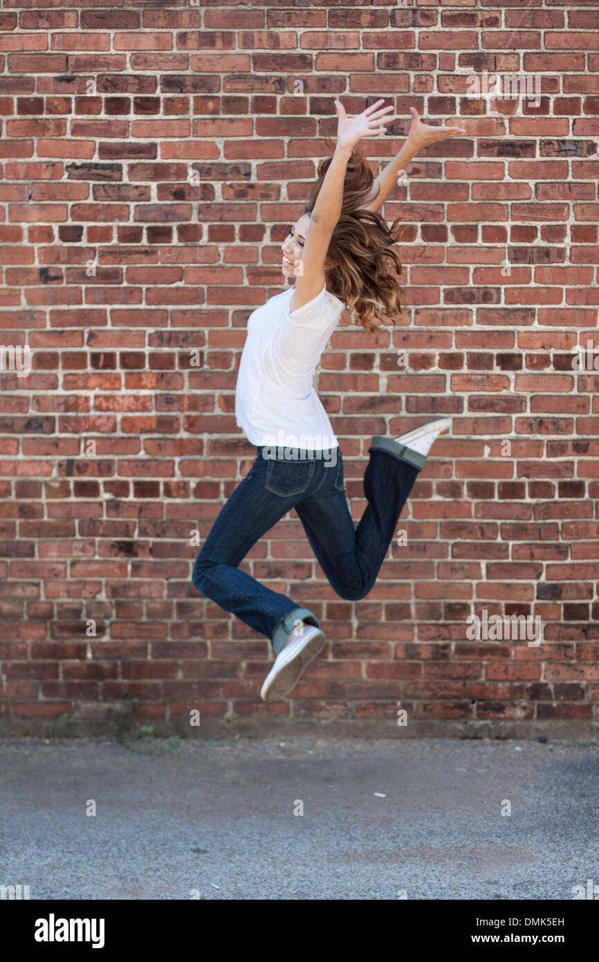 Teenage Jump for Joy - vertical orientation of a lovely, smiling, happy ...