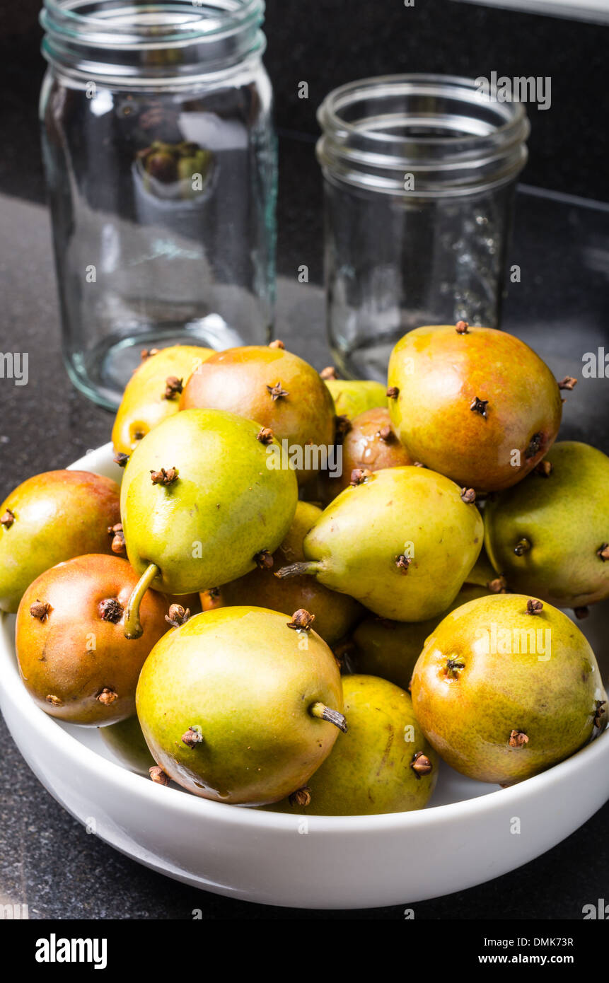 Spiced Seckel pears with cloves being preserved Stock Photo - Alamy
