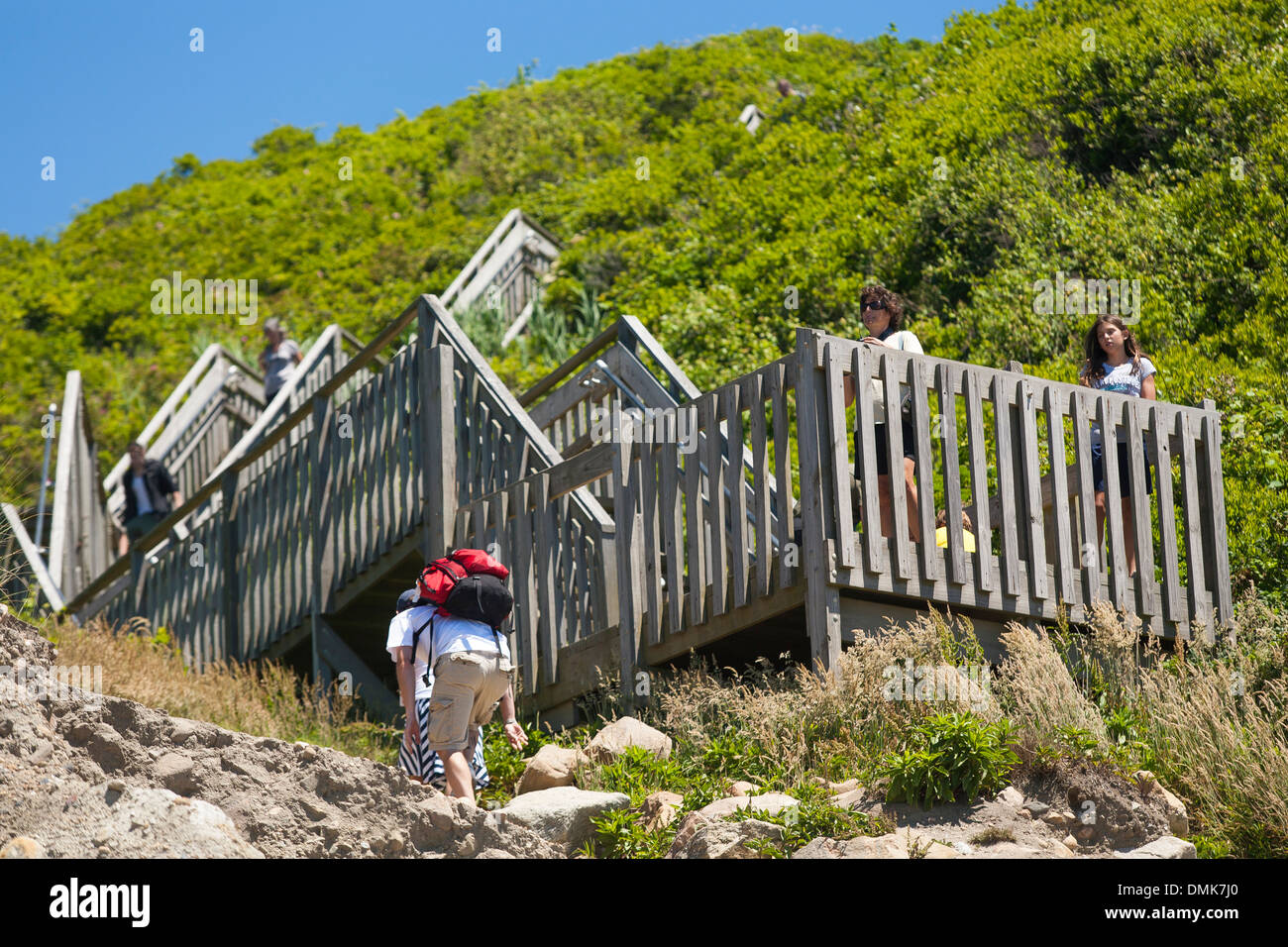 A family walks down famous hundred steps that climb Mohegan Bluffs, a ...