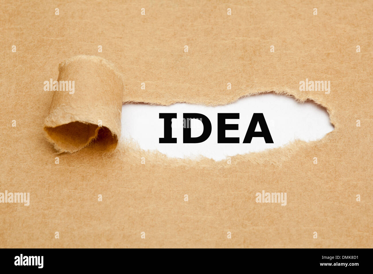 The word Idea appearing behind torn brown paper Stock Photo - Alamy