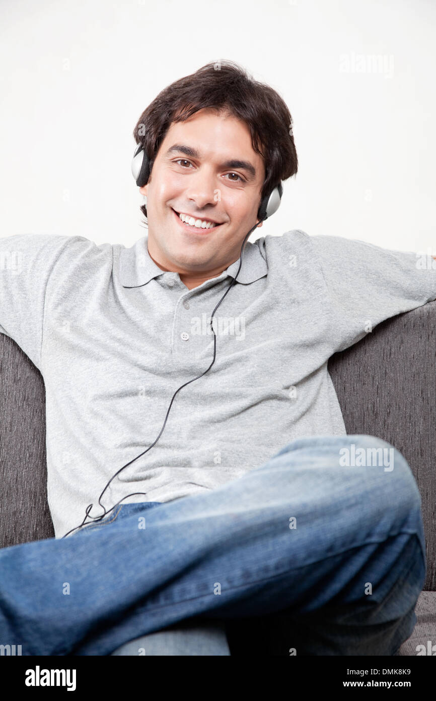 Relaxed Young Man on Couch Stock Photo - Alamy