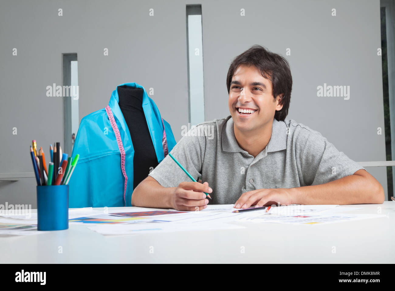 Happy Clothing Designer At Work Stock Photo - Alamy