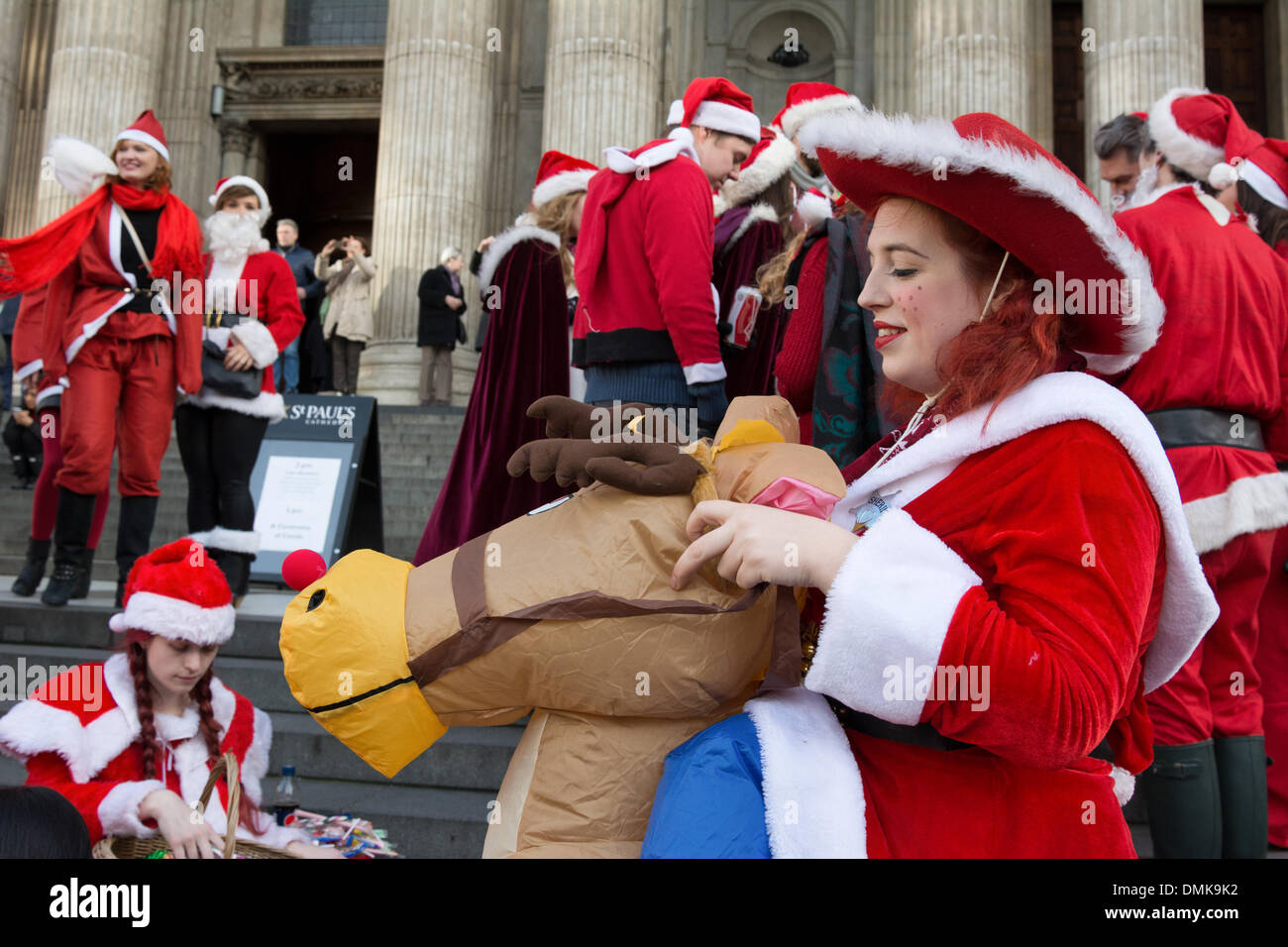 London, UK, 14th Dec, 2013. Revellers get into the Christmas spirit on ...