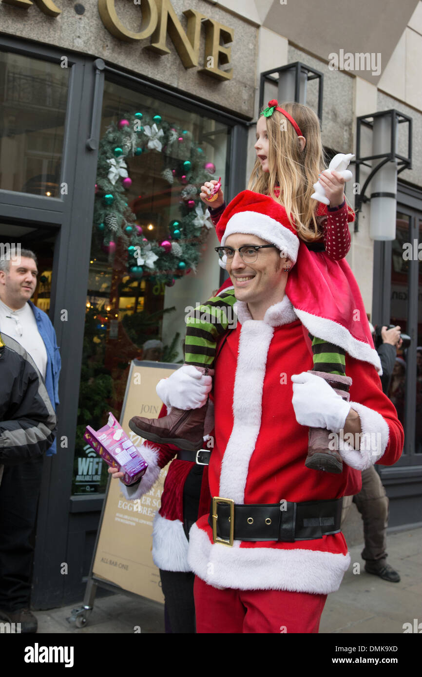 London, UK, 14th Dec, 2013. Revellers young and old having fun during ...