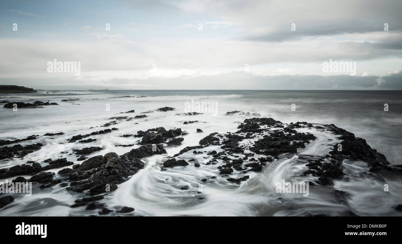 Swirling water over coastal rocks Stock Photo - Alamy