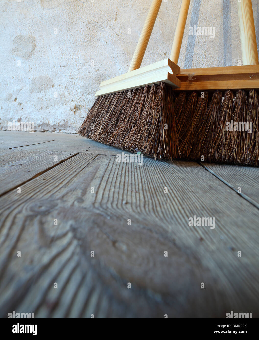 Close up large brooms for house work on old wooden floor of country ...