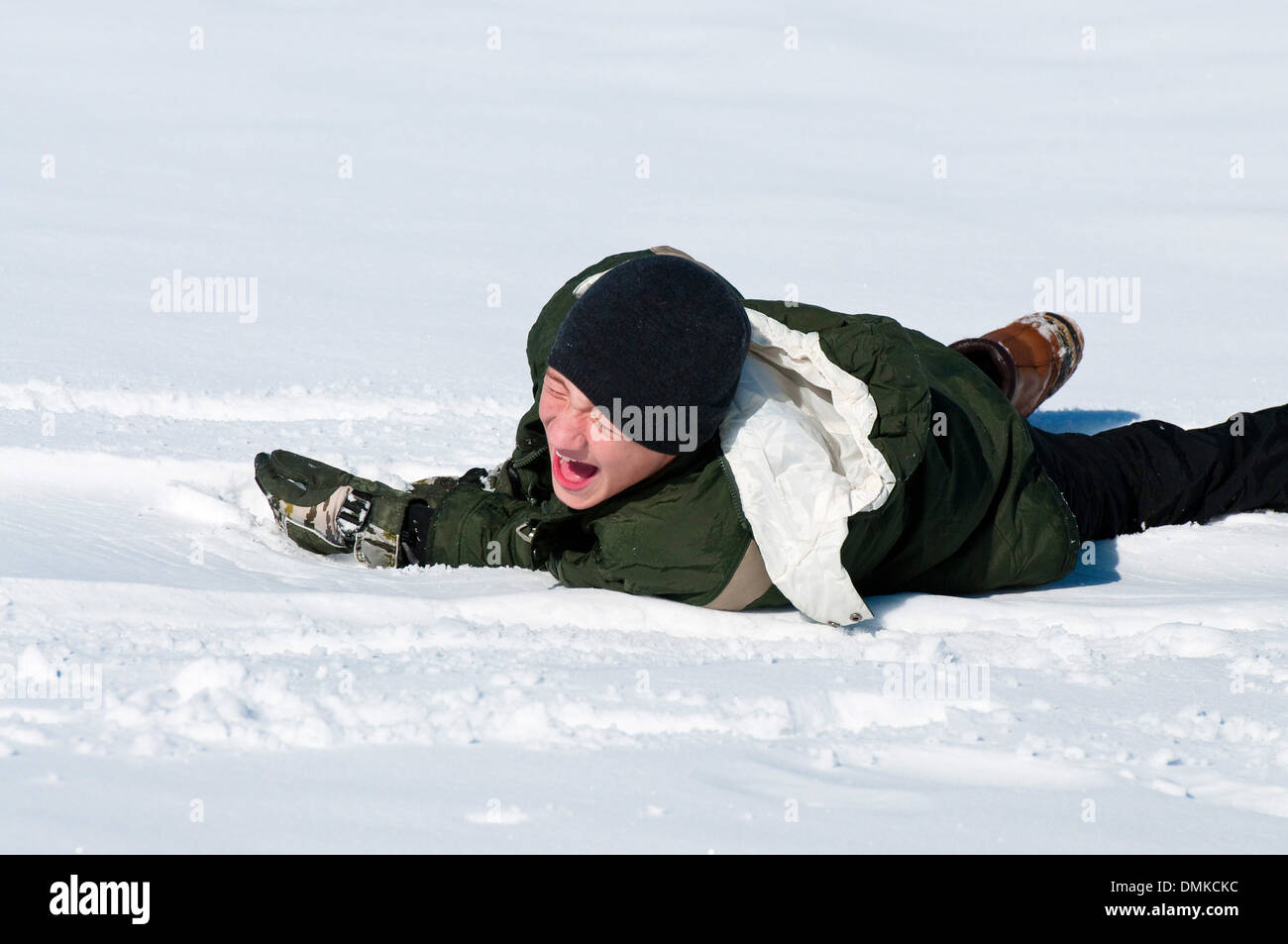 Handsome teen boy laughing in snow laughing Stock Photo - Alamy