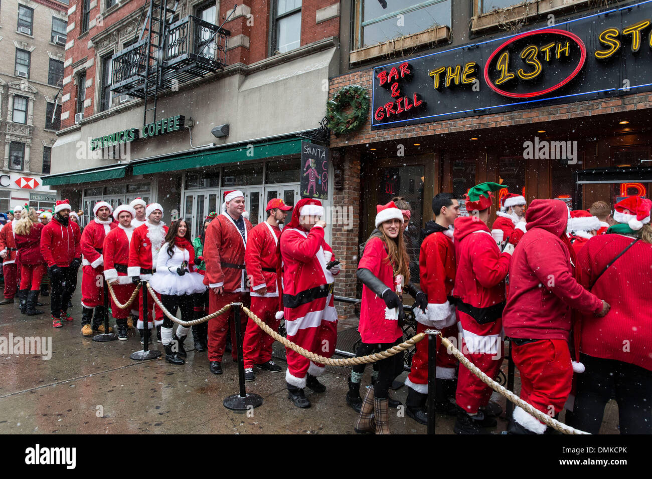 New York, USA. 14th Dec 2013. Revelers participating in SantaCon gather ...