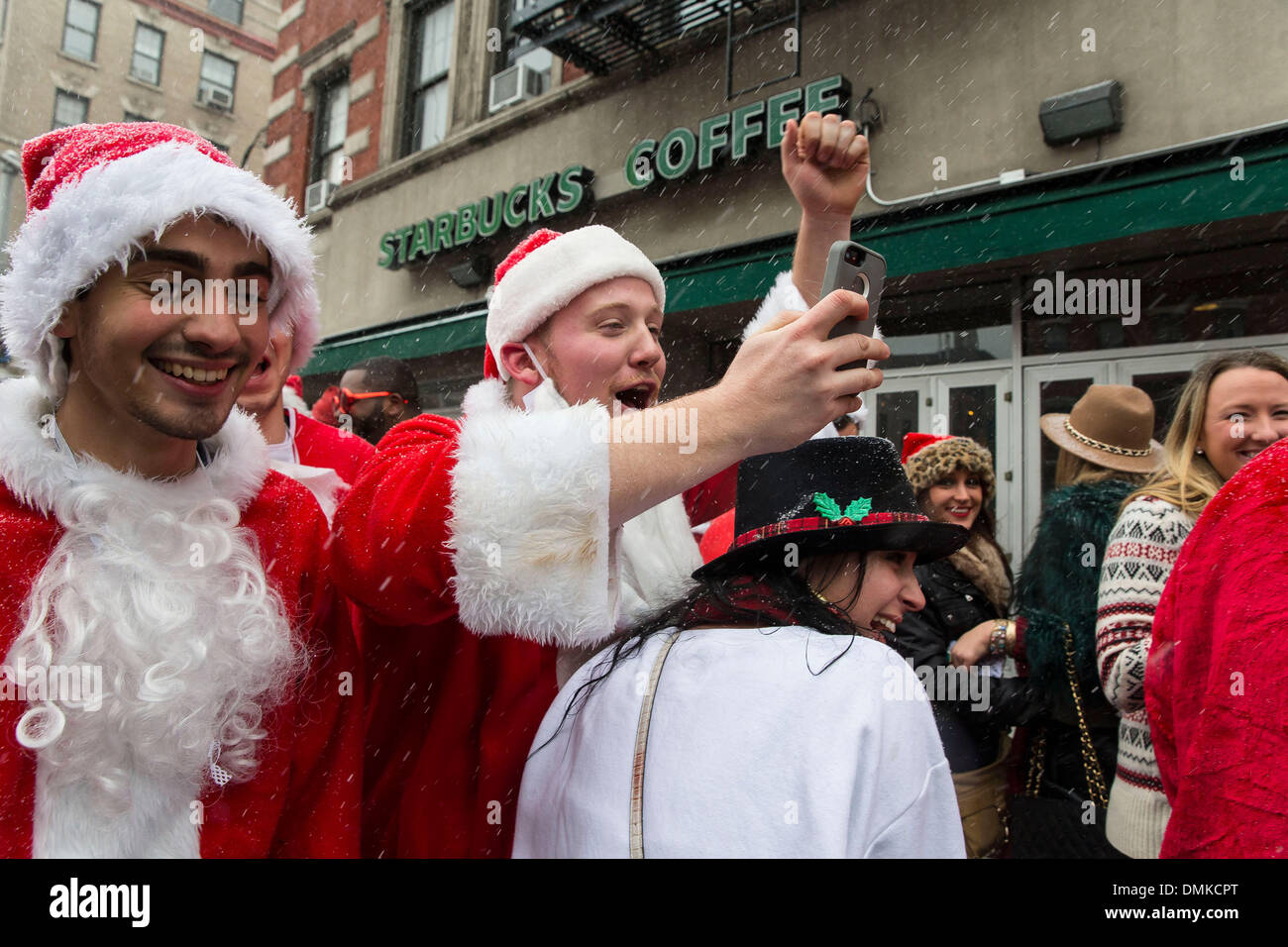 New York, USA. 14th Dec 2013. Revelers participating in SantaCon gather ...