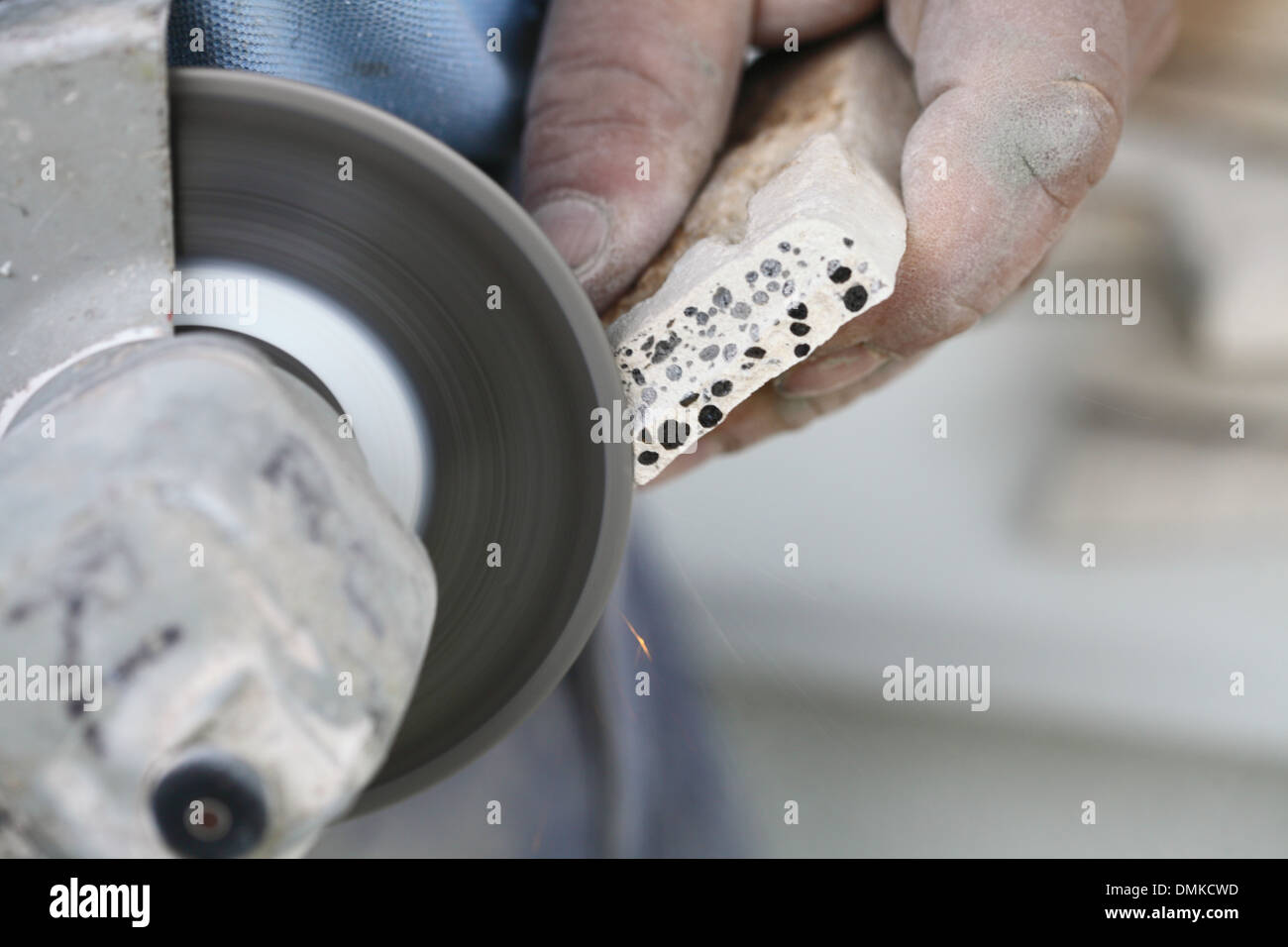Renovation at home worker cuts tile with angle grinder electric tool ...