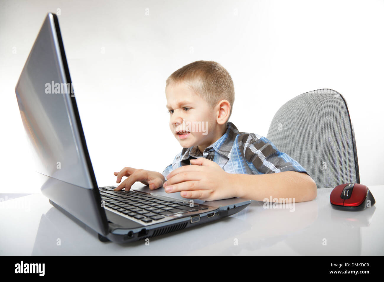 Computer addiction emotional child boy with laptop notebook playing ...