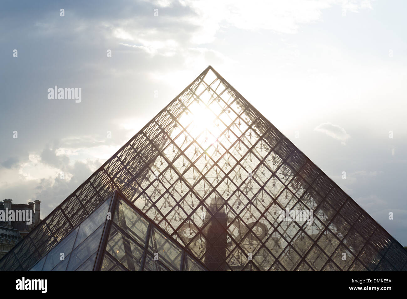 The late afternoon sun shining through the pyramid of the Louvre Stock ...