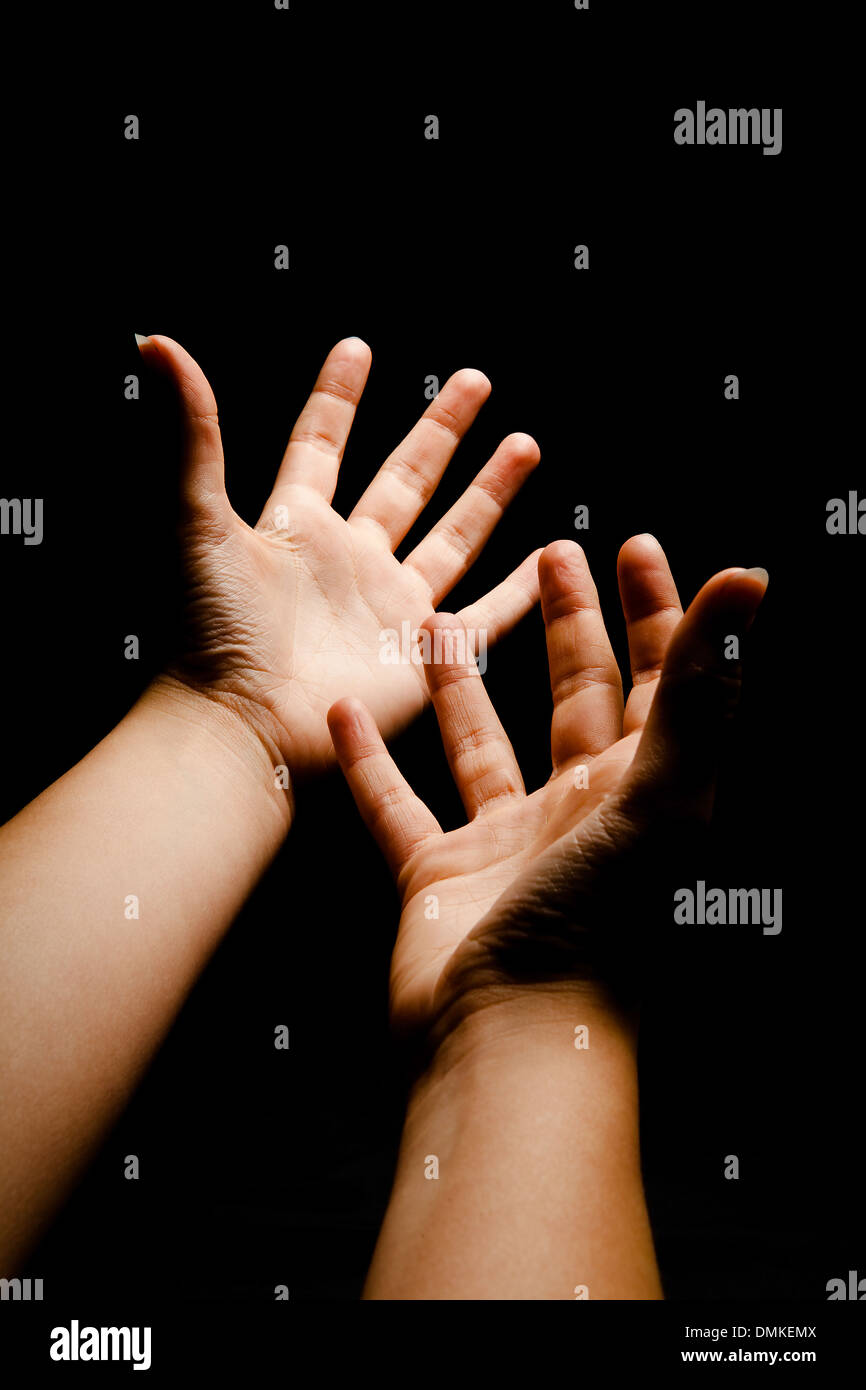 Hands in outer space reaching into the darkness Stock Photo - Alamy