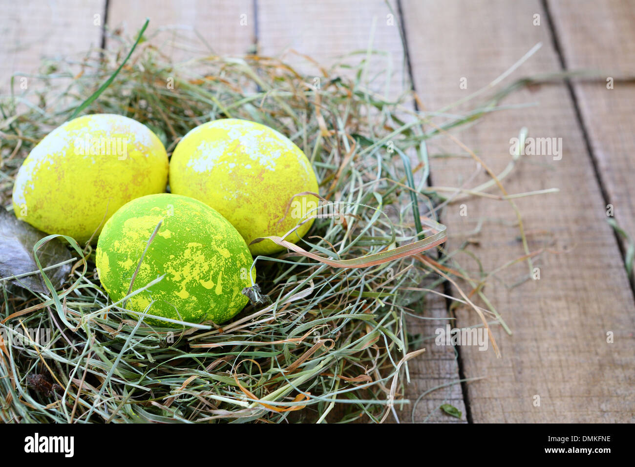 Easter eggs in the hay, holidays food Stock Photo - Alamy