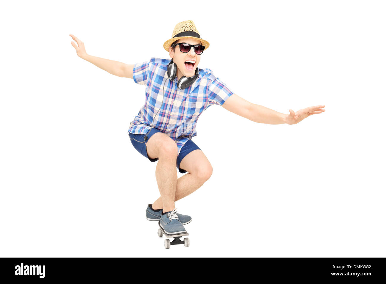 Excited guy with cap and sunglasses skating on a skate board Stock ...