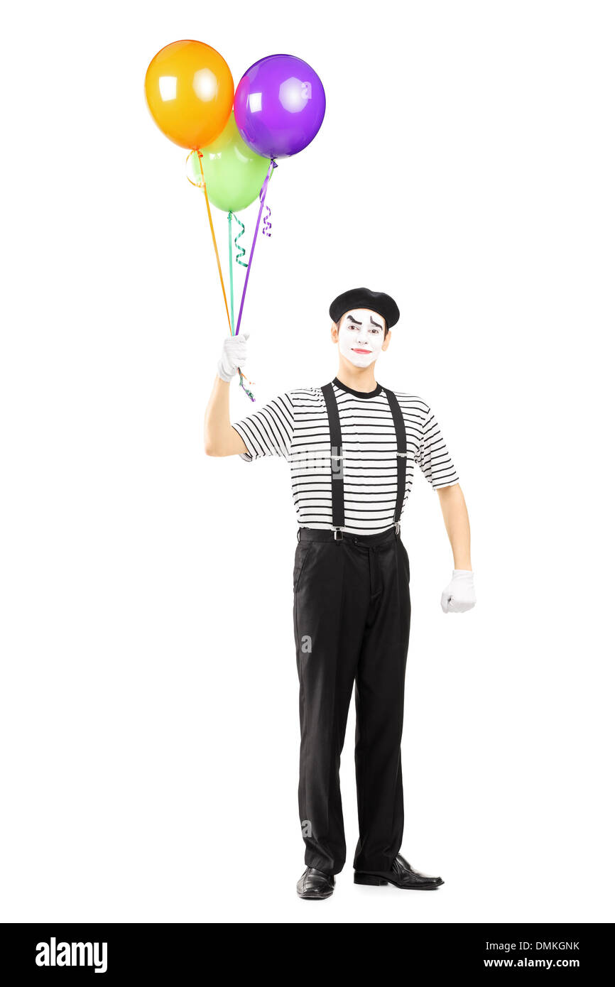 Full length portrait of a young mime artist holding balloons and ...
