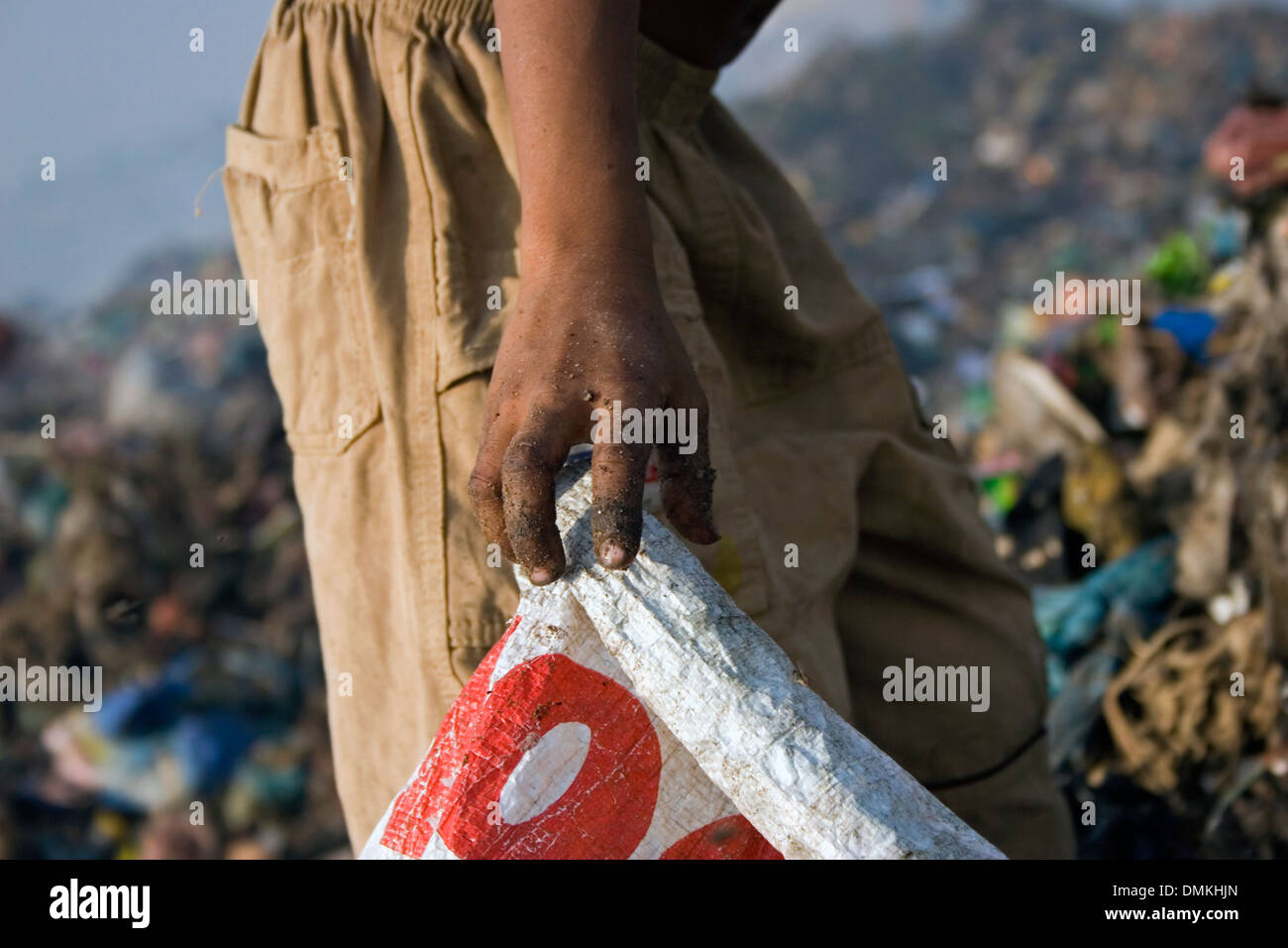 A young child laborer boy is collecting recyclable at the Stung ...