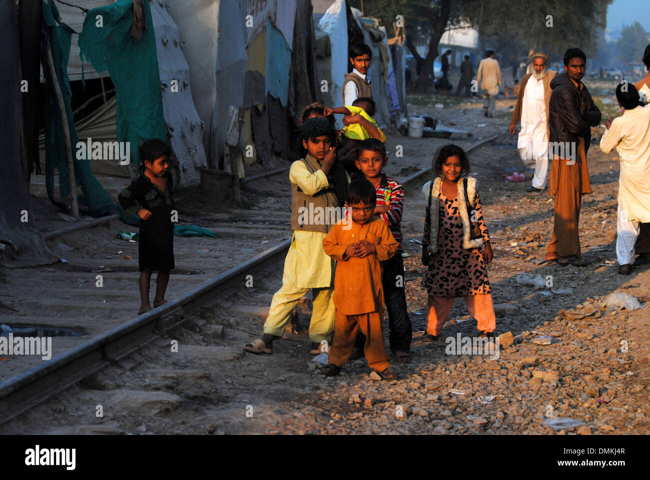 Peshawar. 15th Dec, 2013. Pakistani children play near their makeshift ...