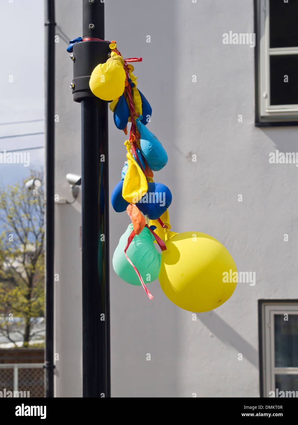 The party`s over, colourful balloons deflated hanging outside a block ...