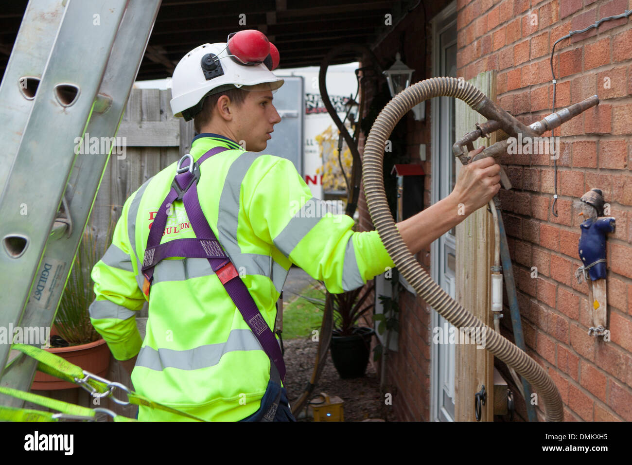 Blown in Cavity wall insulation at a existing building by an installer ...