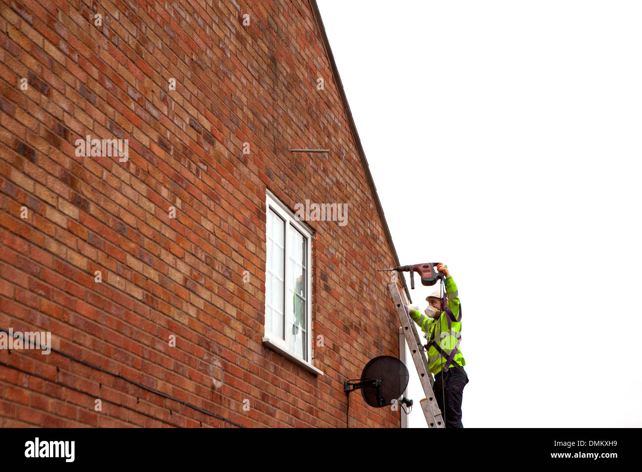 Blown in Cavity wall insulation at a existing building by an installer ...