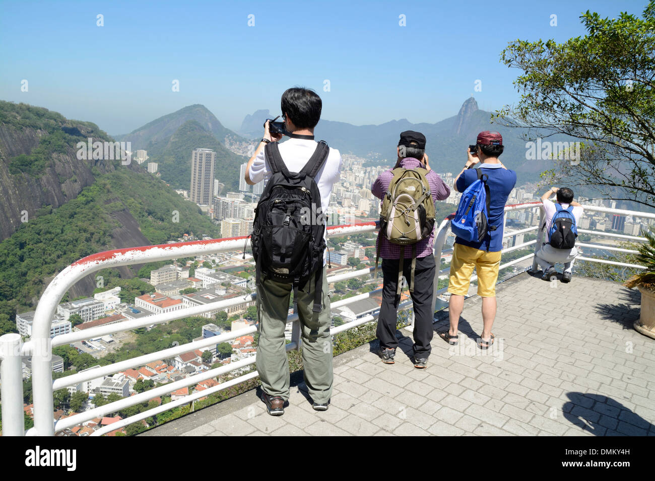 Three tourists are taking photographs of the panoramic view from Urca ...