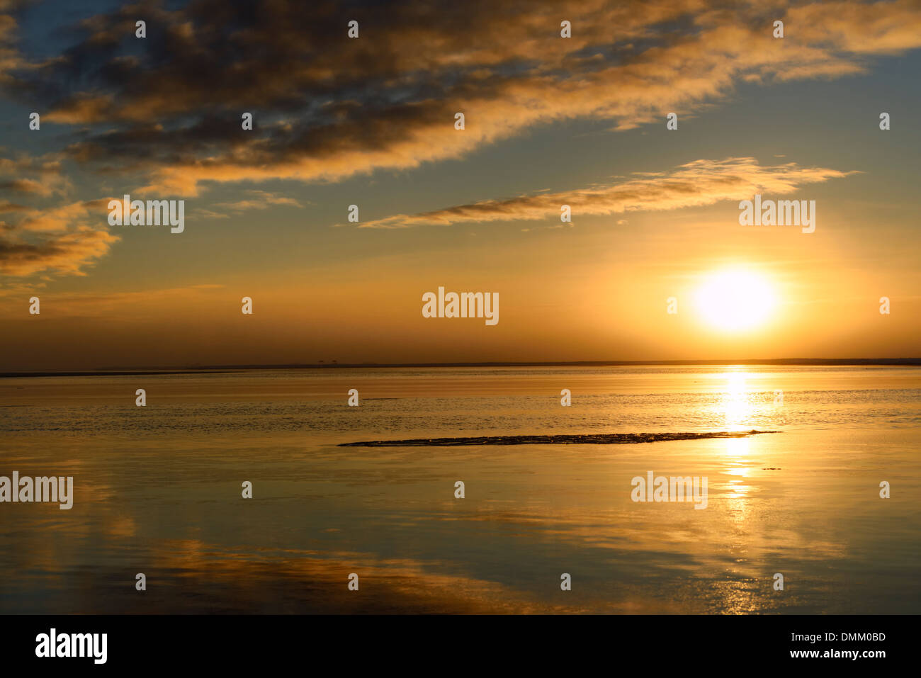 Setting sun over calm water of the Beaufort Sea Arctic Ocean at Barter ...
