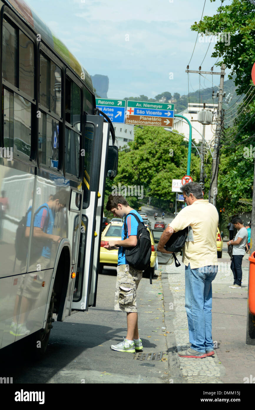 Bus passengers queuing to board a Rio bus in Rio de Janeiro in Brazil ...