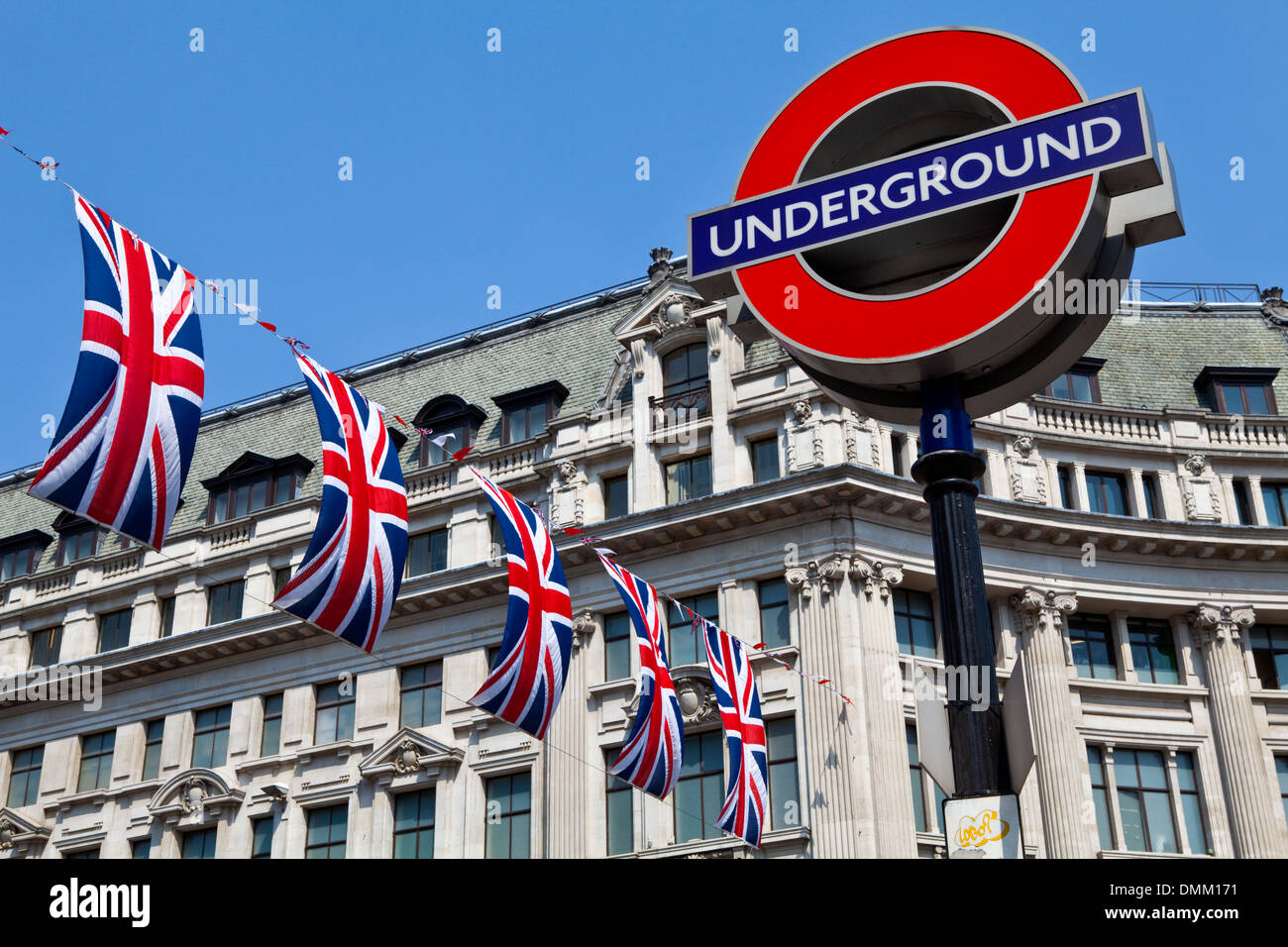 London Underground sign and Union Flags in London Stock Photo - Alamy