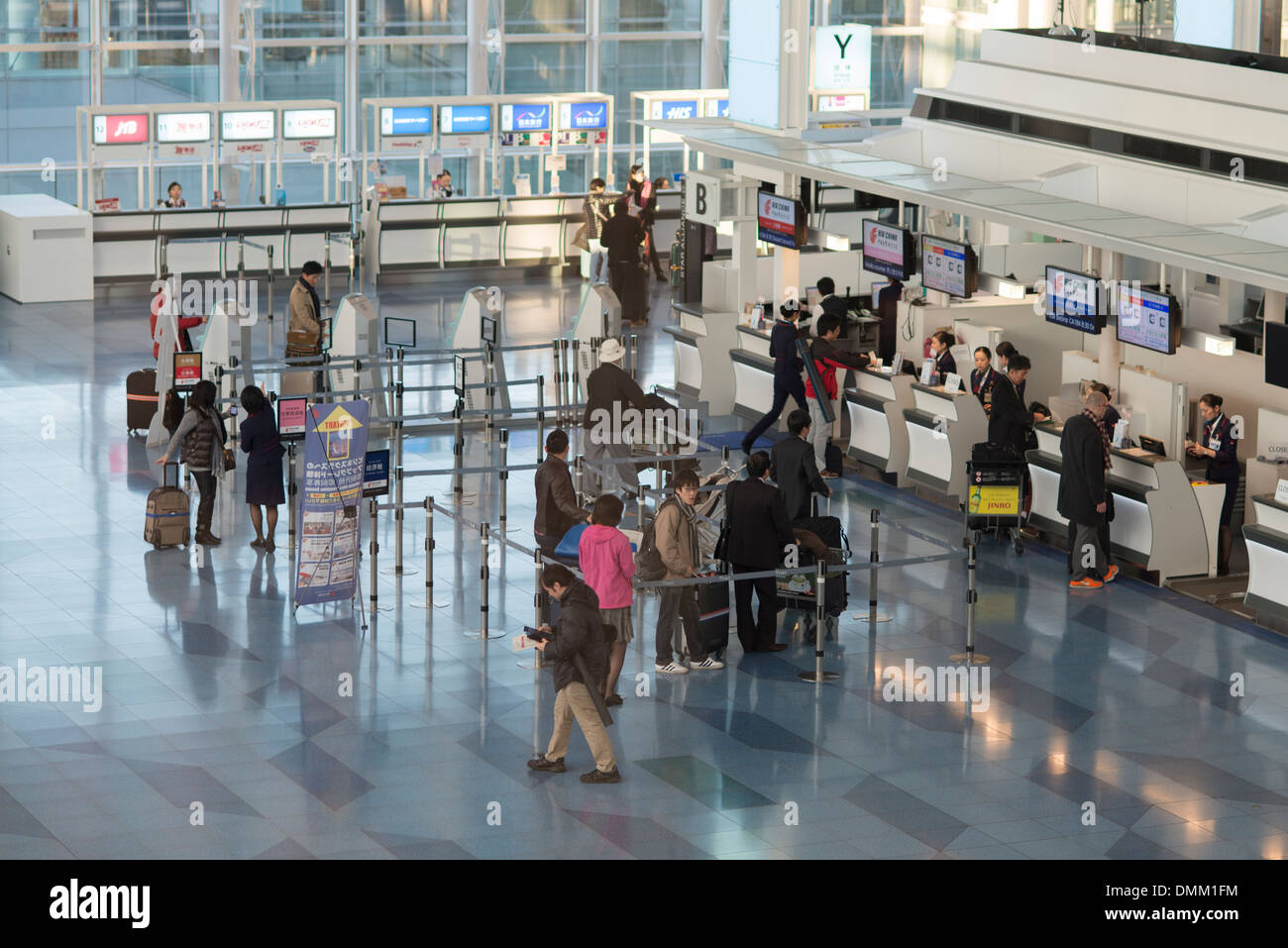 PAssengers line up at the check in at Tokyo International Airport or ...