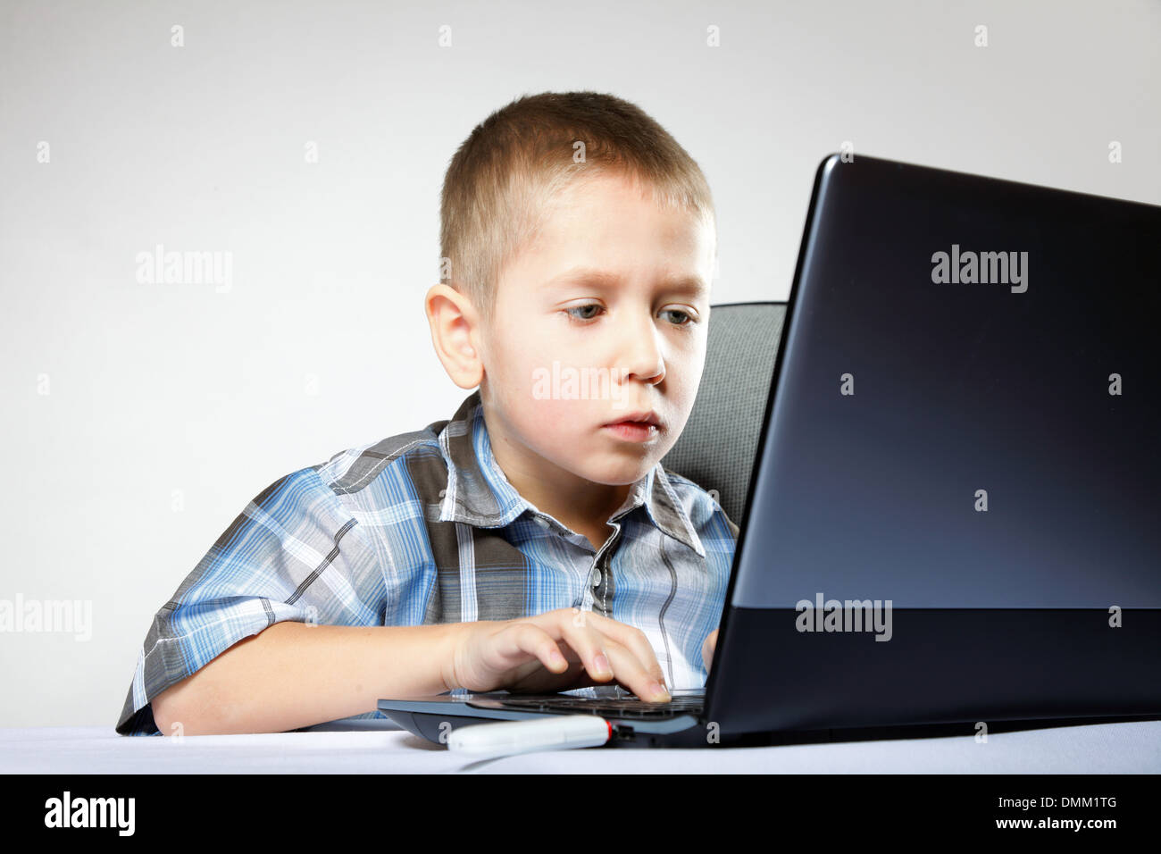 Computer addiction child boy with laptop notebook white background ...