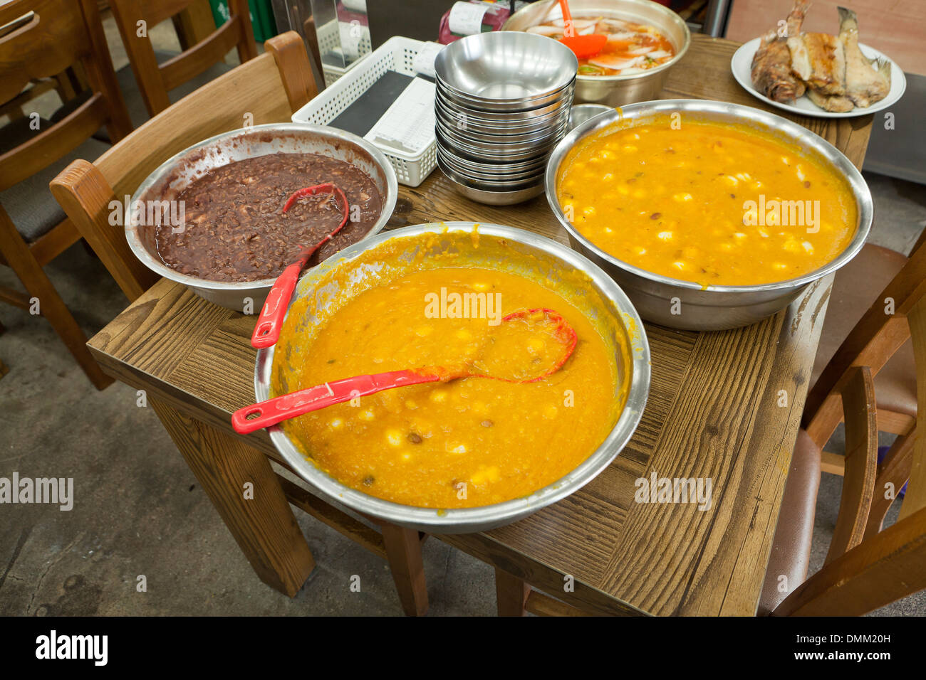 Pumpkin and red bean juk (Korean congee / porridge / gruel) in bowls ...