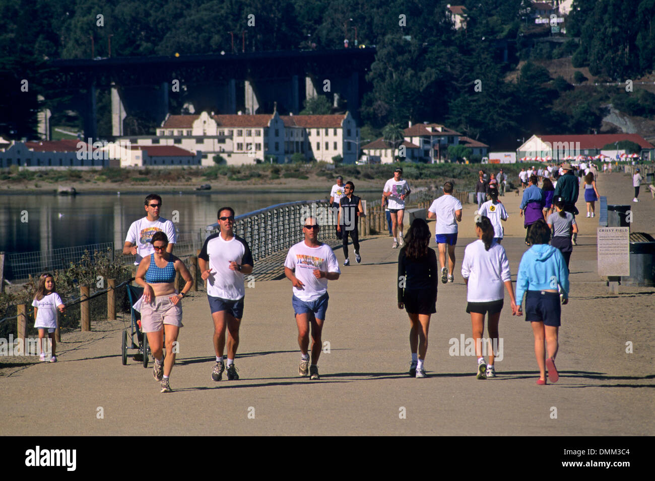 People running and walking on path at Crissy Field in the Presidio, San ...