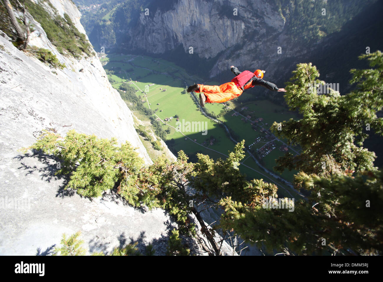 Man within his tracking suit is diving down the valley. He jumped from ...