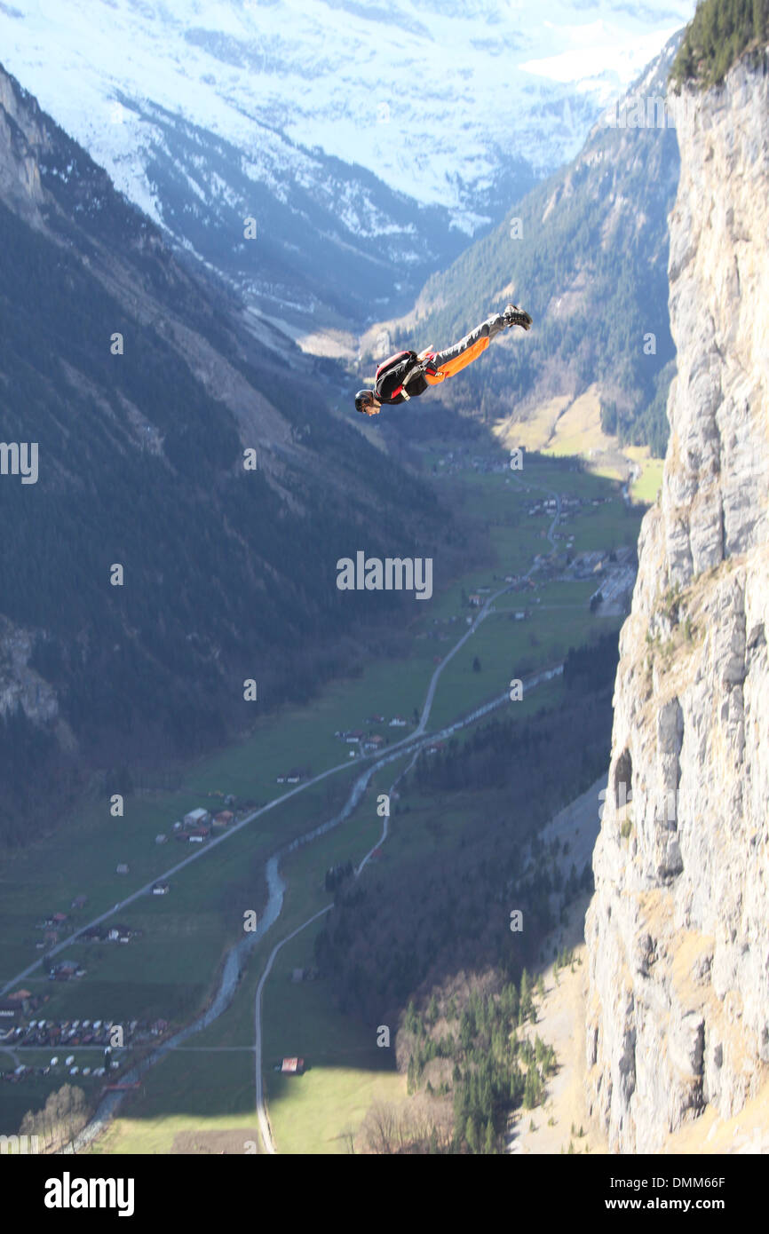 Man within his tracking suit is diving down the valley. He jumped from ...