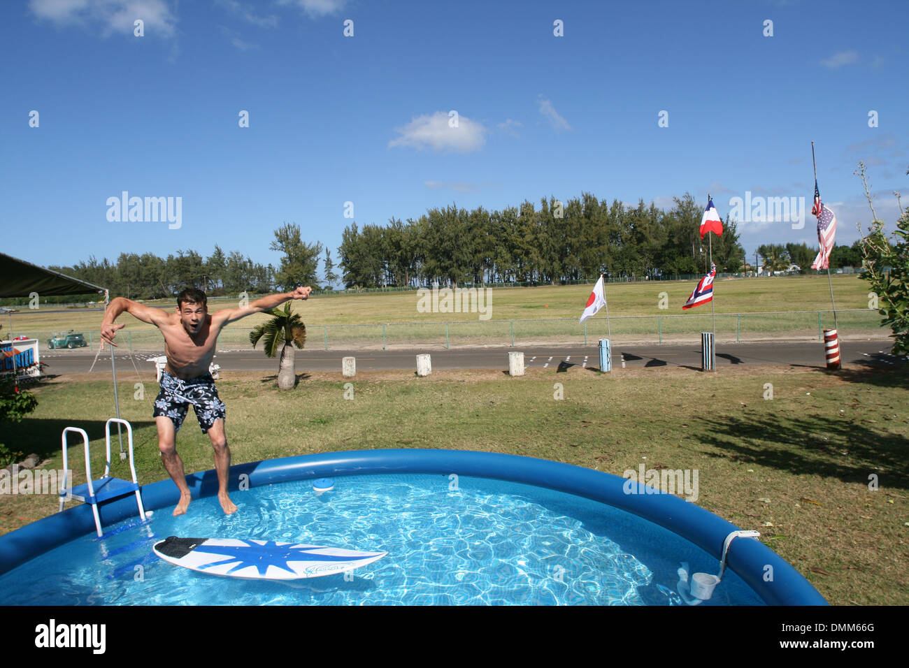 Fun diver is jumping on his surf board ready in the swimming pool. Soon ...